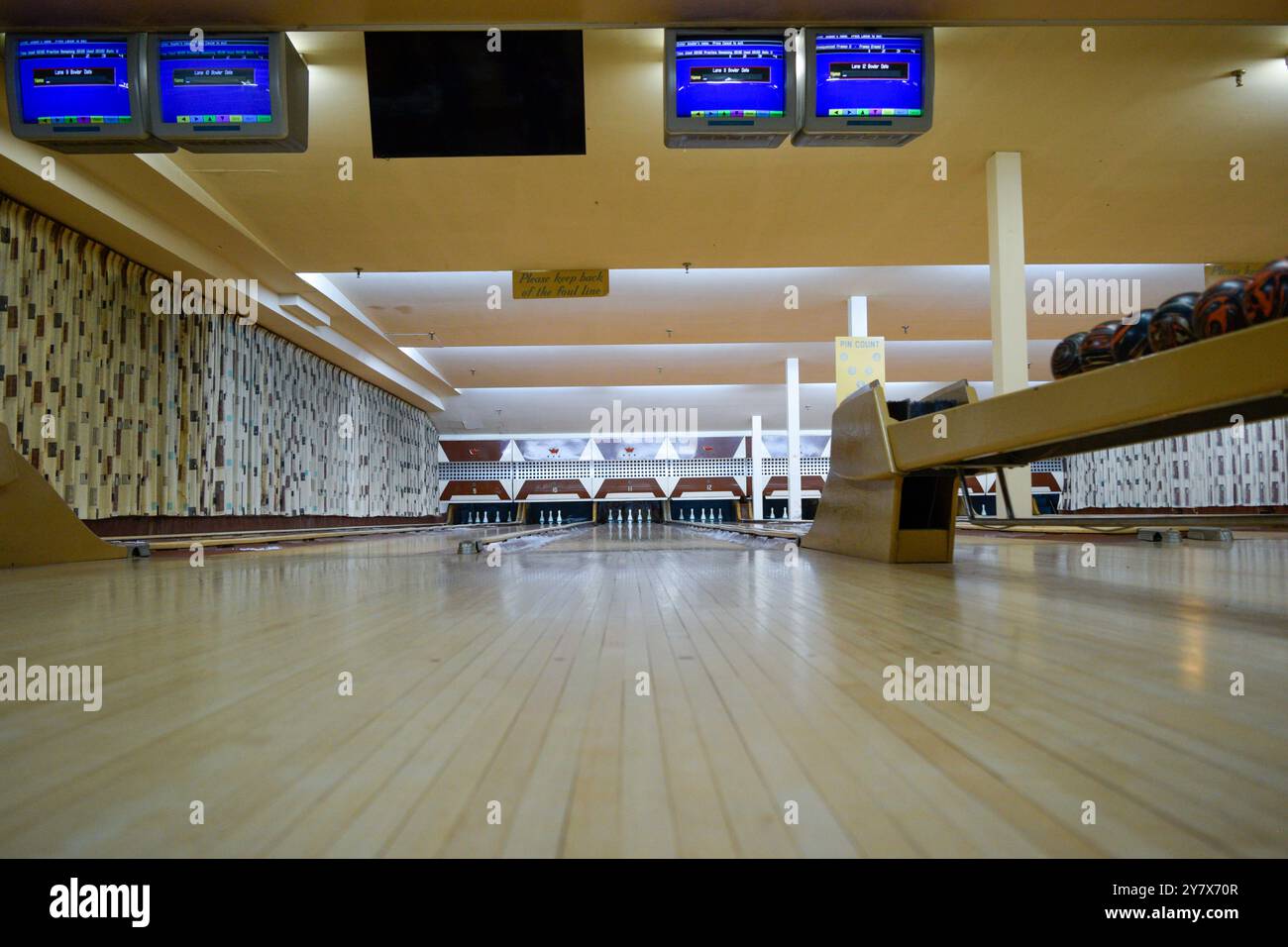 90s-style bowling alley featuring retro decor, wooden lanes, bowling ...