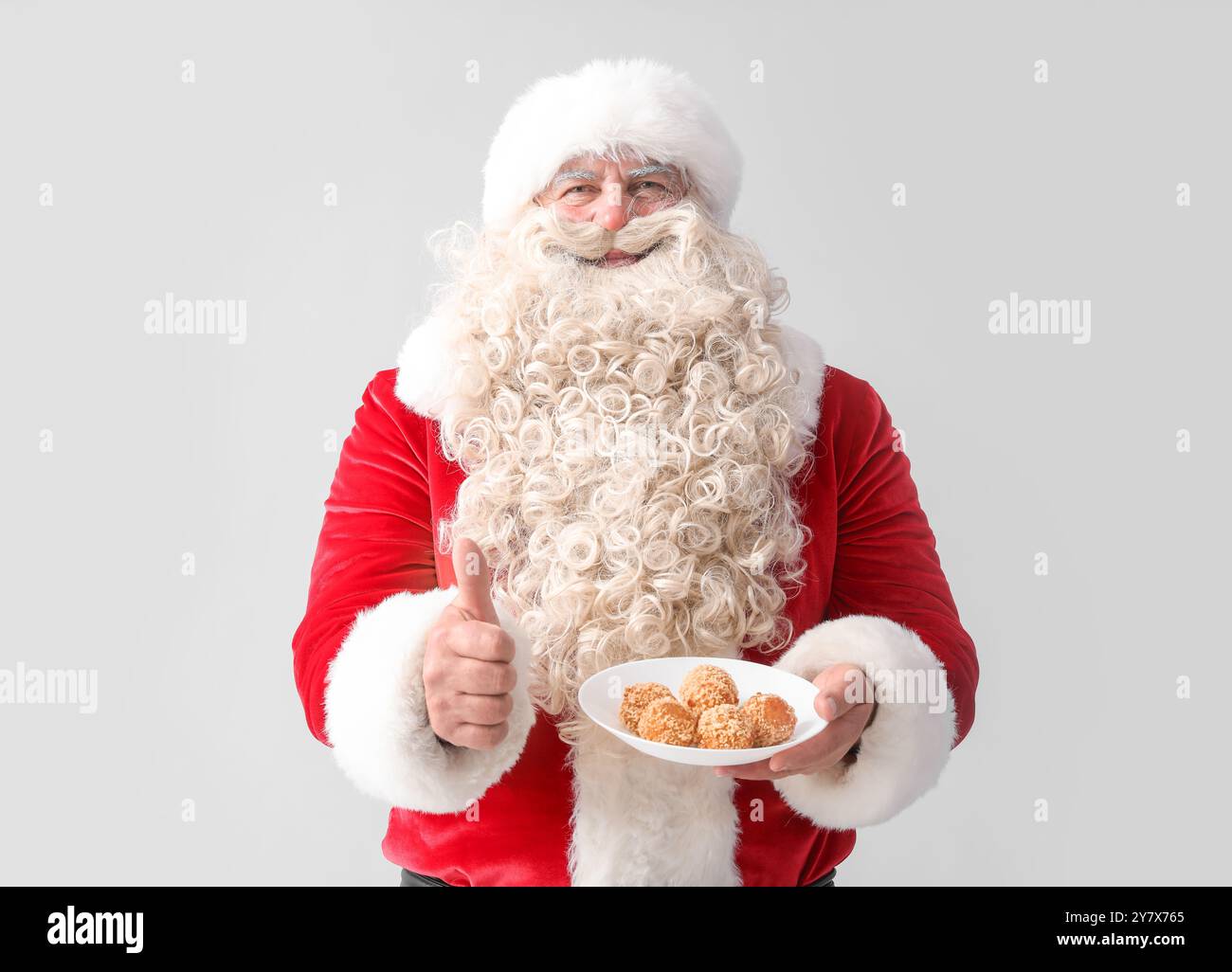 Santa Claus with tasty falafel balls showing thumb-up on white ...