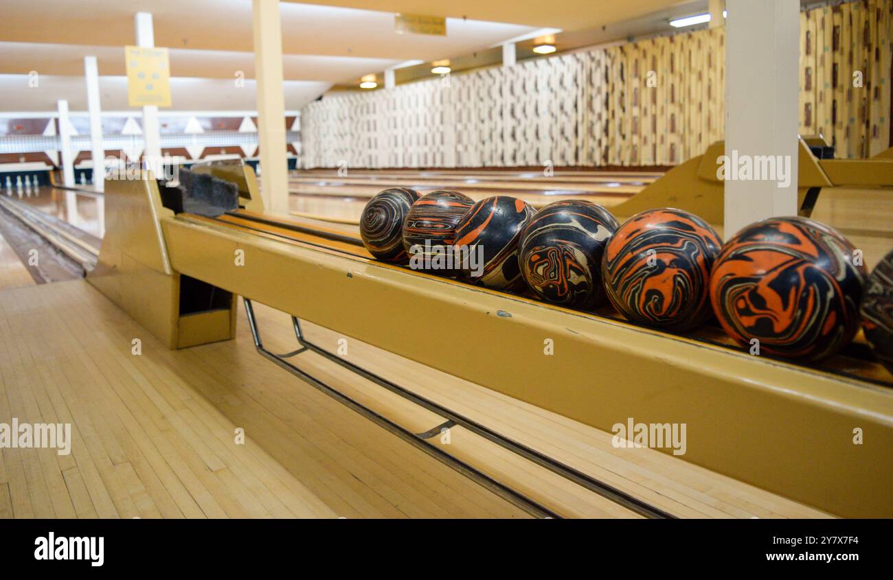 Bowling balls stacked in a retro-style bowling alley, showcasing ...