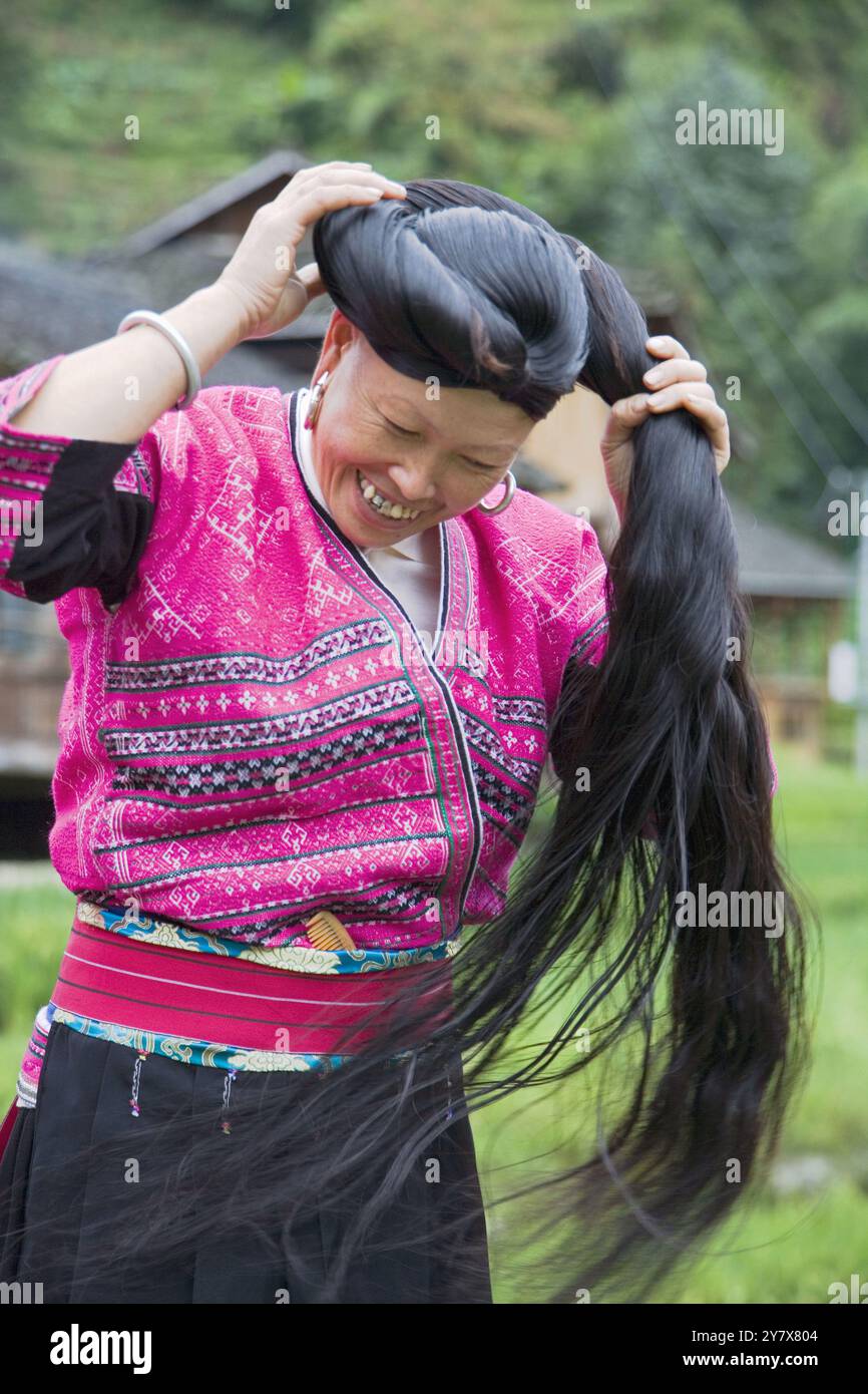 Long Haired Yao woman coiling her hair, a tradition kept by the Red Yao ...