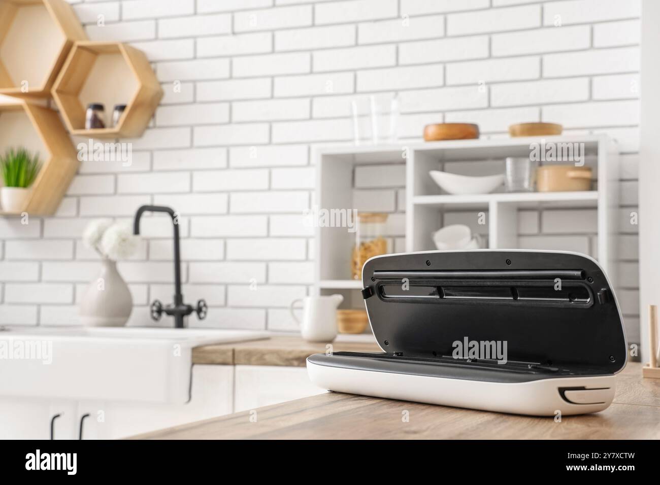 Vacuum sealer machine for food on kitchen table Stock Photo - Alamy