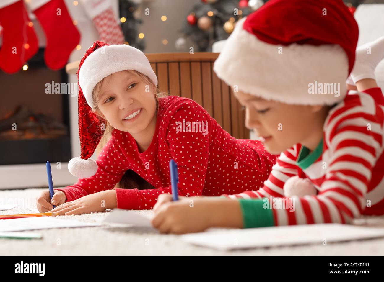 Cute happy little children dressed as elves writing letter to Santa ...
