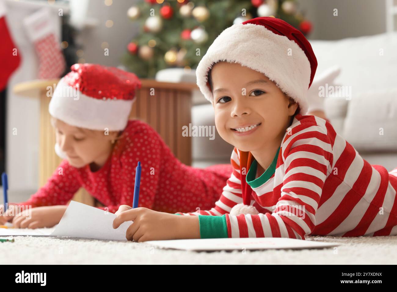 Cute happy little children dressed as elves writing letter to Santa ...