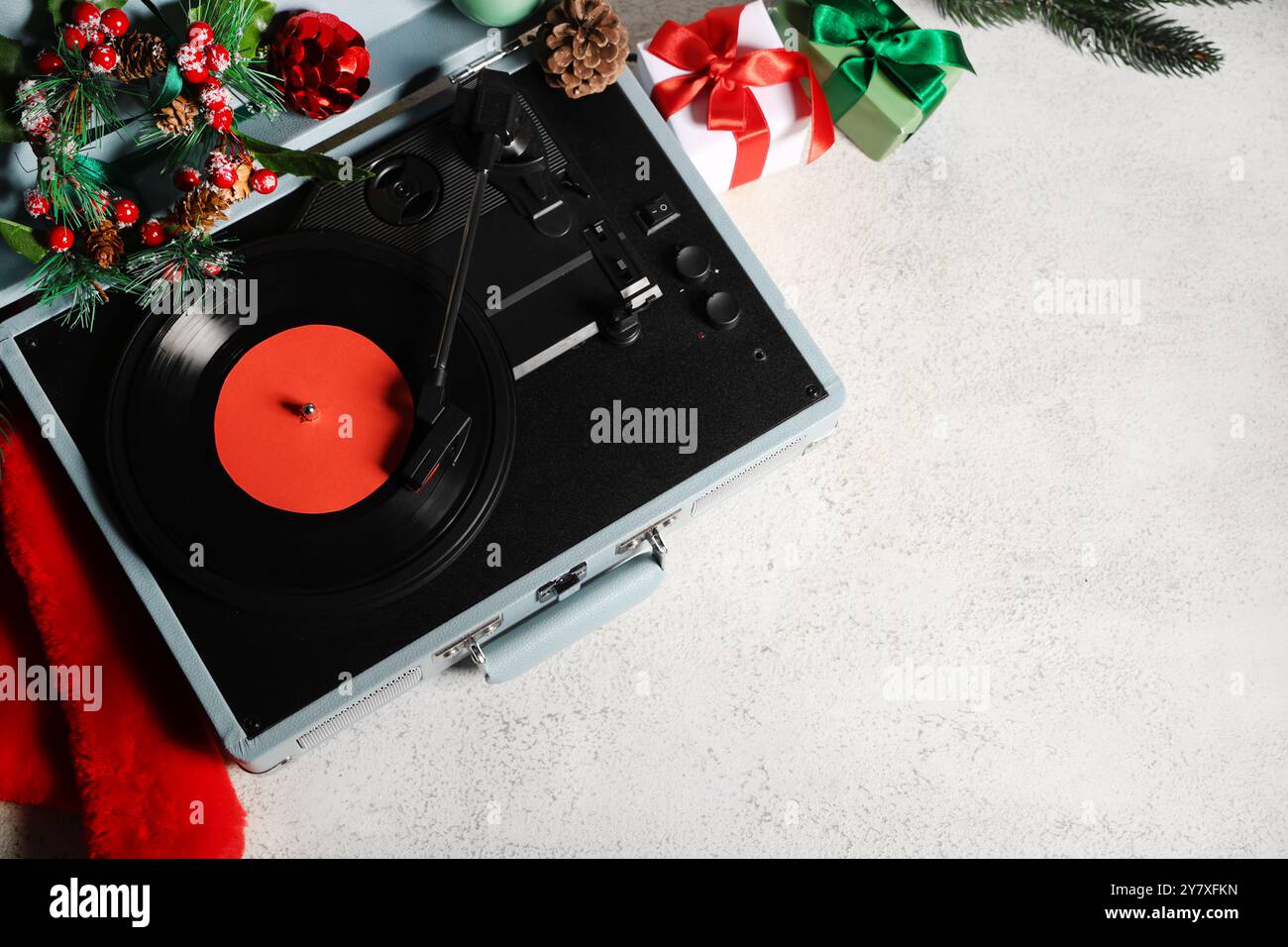 Vinyl record player with Christmas wreath, balls and gift boxes on ...