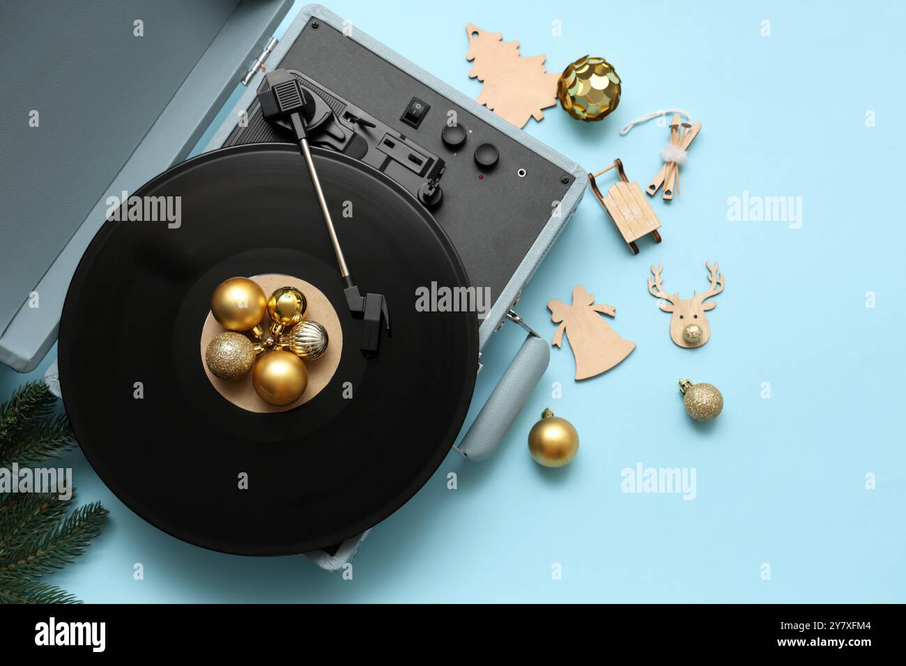 Vinyl record player with disc, Christmas decorations and fir branches ...
