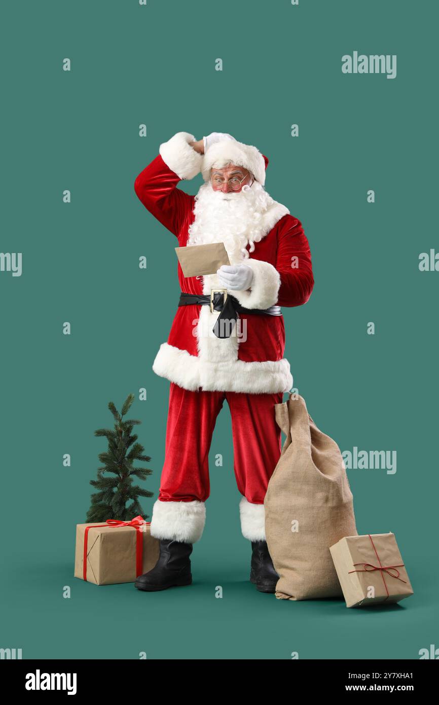 Shocked Santa Claus with bag, letter, gift boxes and Christmas tree on ...