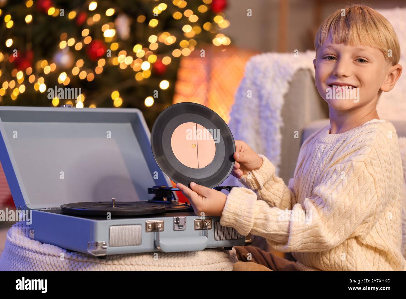 Cute little boy with vinyl disk for record player at home on Christmas ...