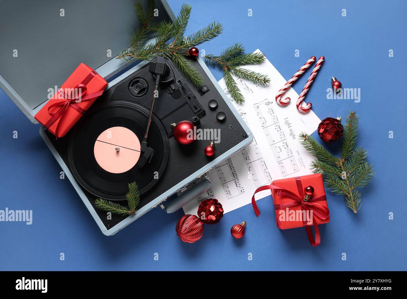 Composition with vinyl record player, music sheets, Christmas gifts and ...
