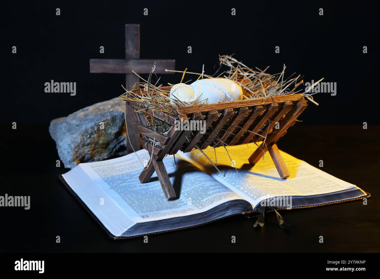 Manger with baby, wooden cross and Bible on dark background. Christmas ...