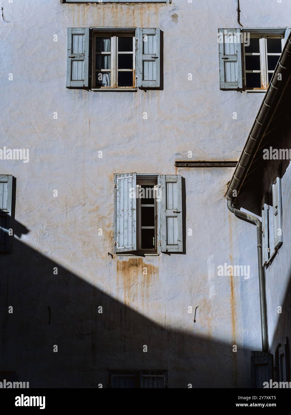 A weathered facade of a building in Briançon, France, featuring ...