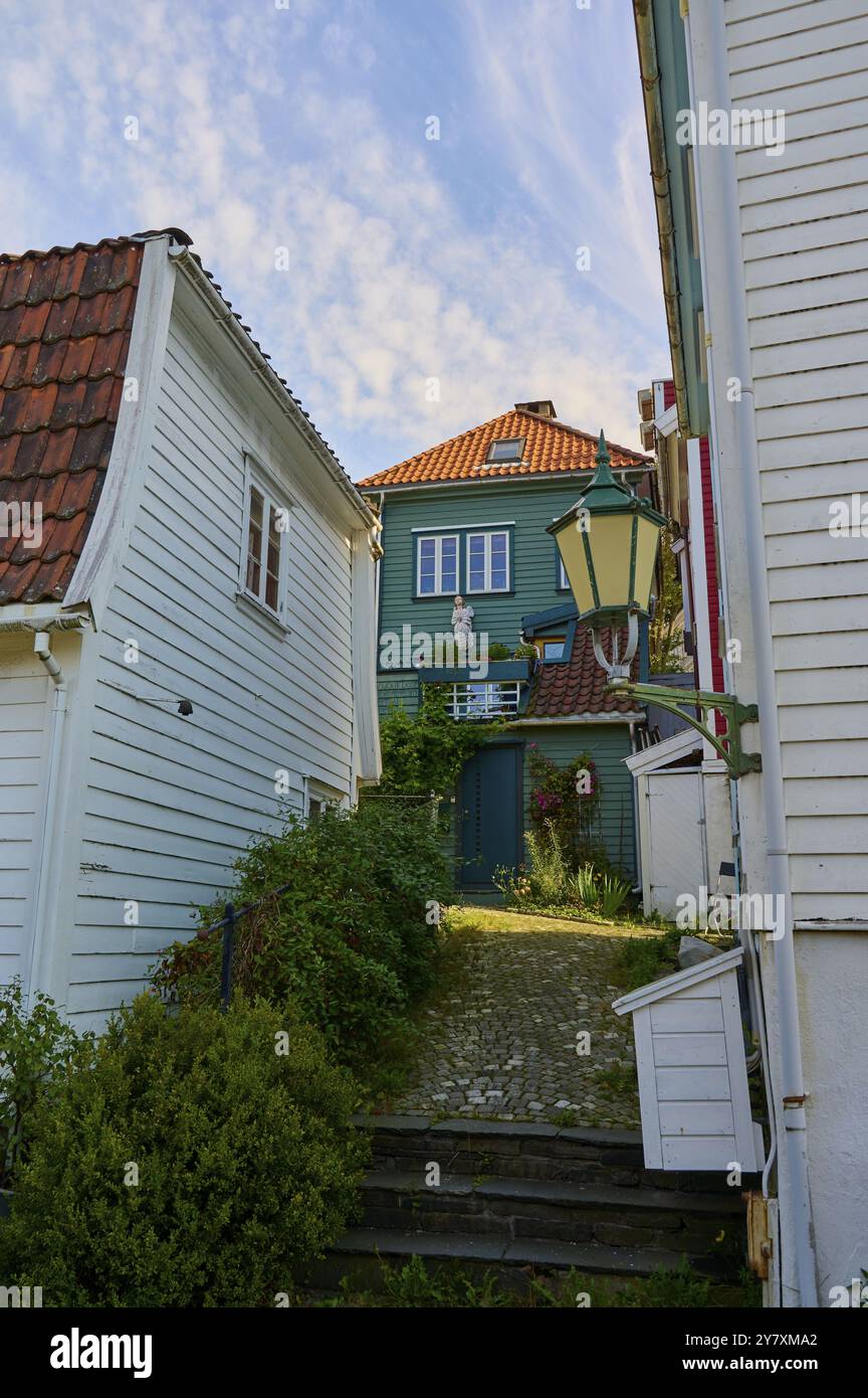 Narrow alley with cobblestones between historic houses, foreground ...