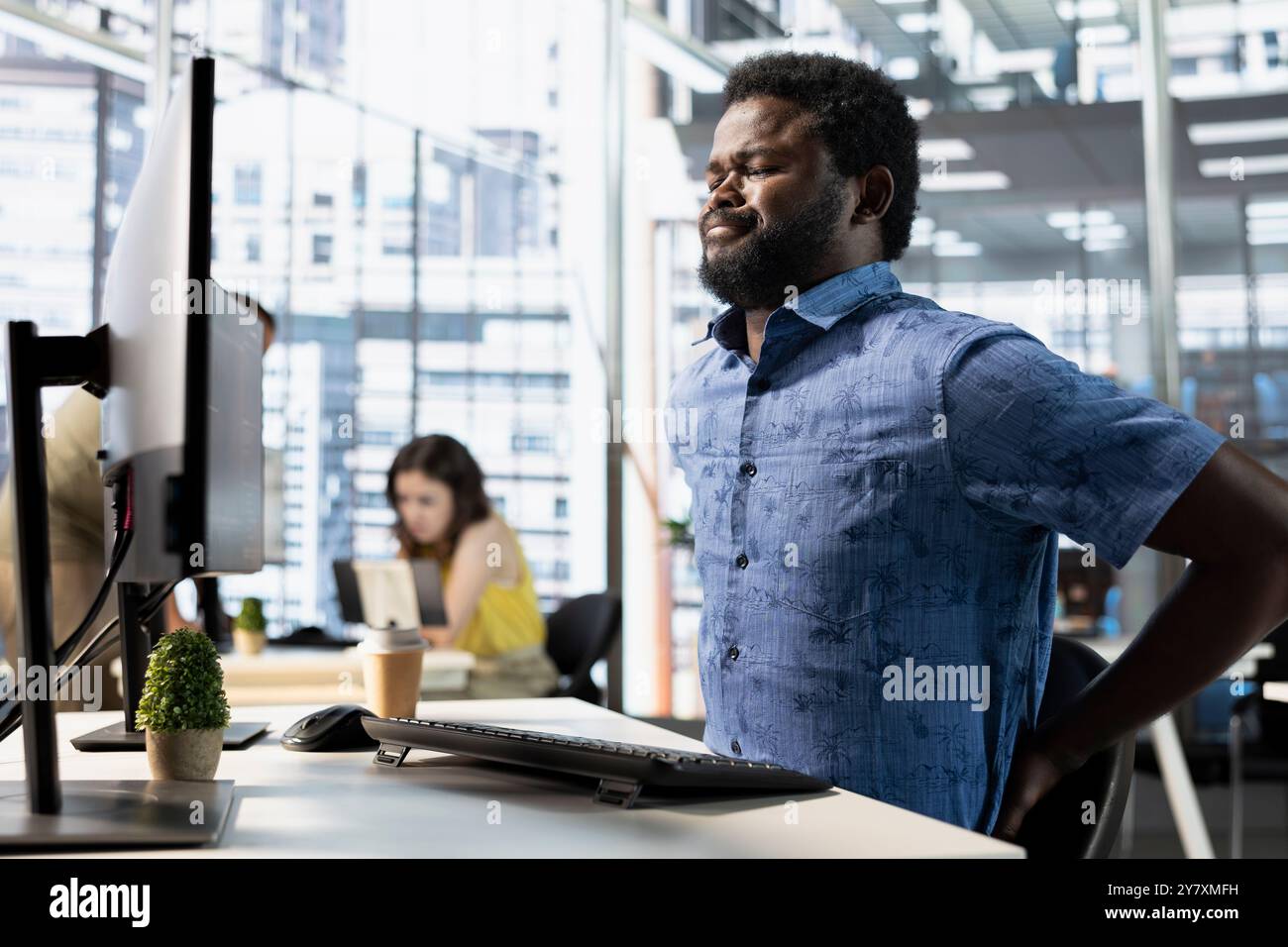 Worker suffering backache from incorrect posture, working with machine ... Worker suffering backache from incorrect posture, working with machine ...