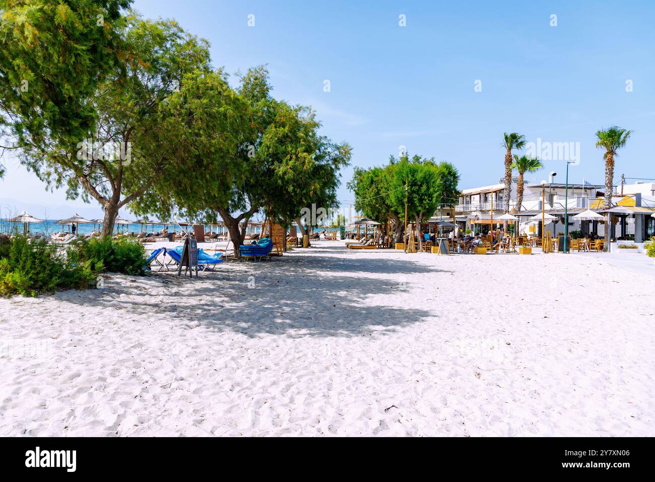 Sandy beach and promenade with taverns and cafes in Marmari on the ...