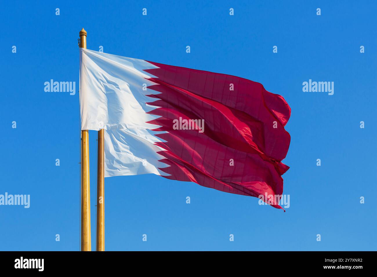 The national flag of Qatar flying proudly over Doha, Qatar Stock Photo ...