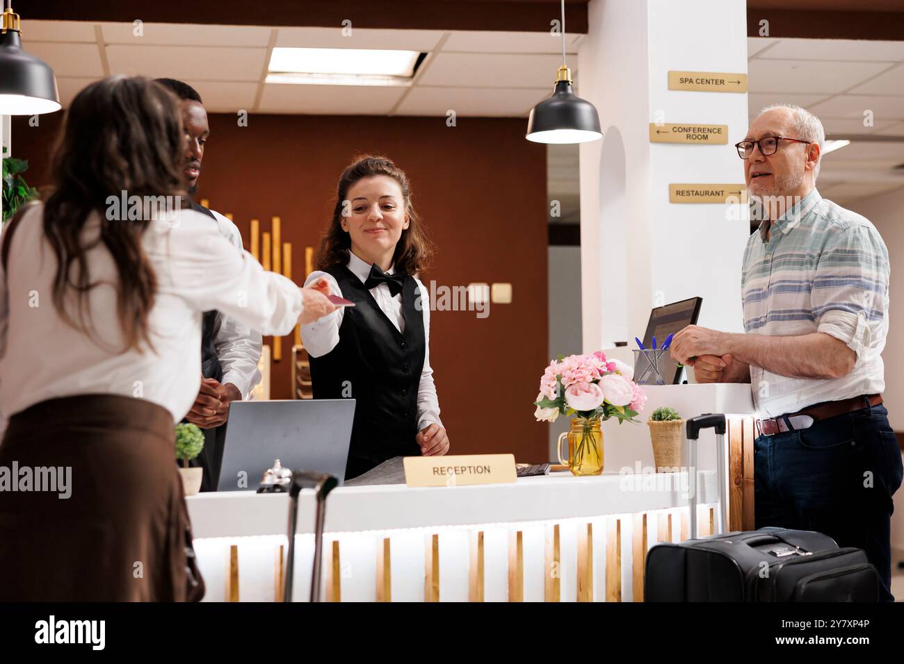 Female tourist providing personal documents to concierge for ...