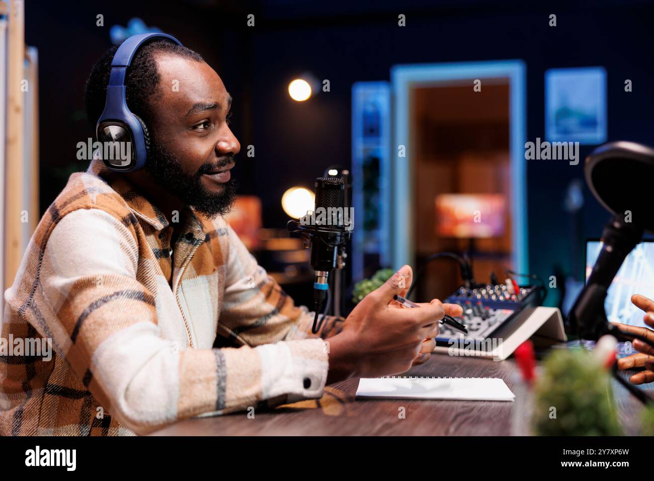 African American guy is speaking into microphone while conducting ...