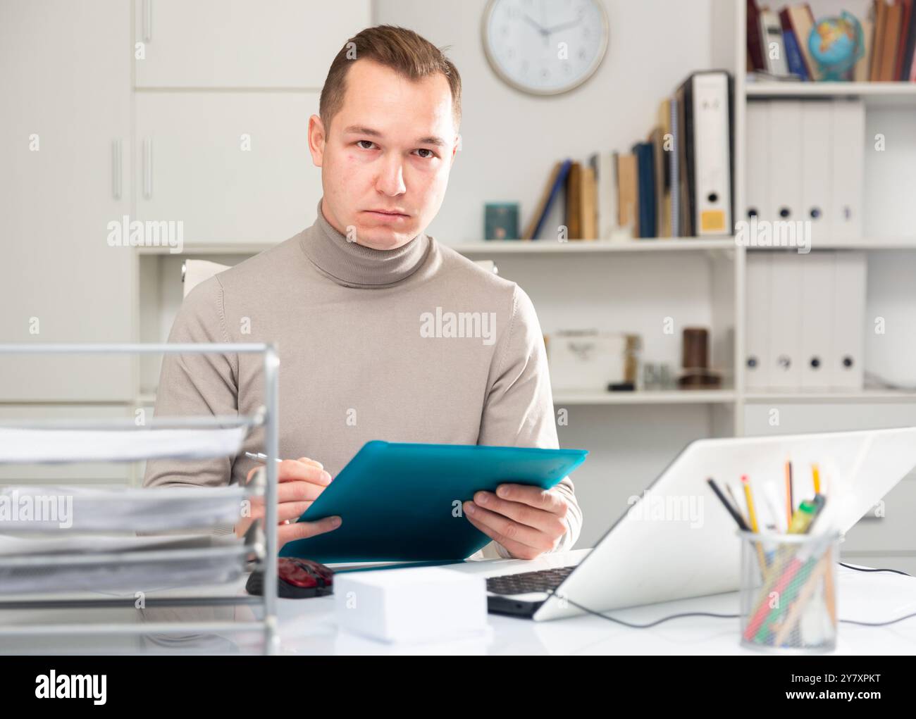 Male office worker doing paperwork Stock Photo - Alamy