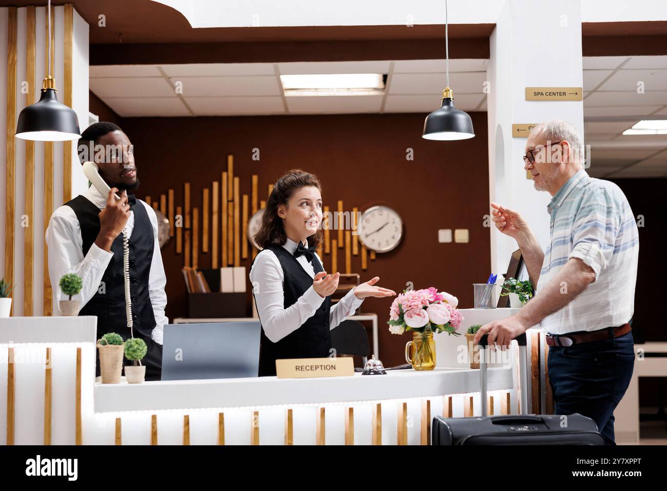 Guest arriving checking in man luggage hi-res stock photography and ...