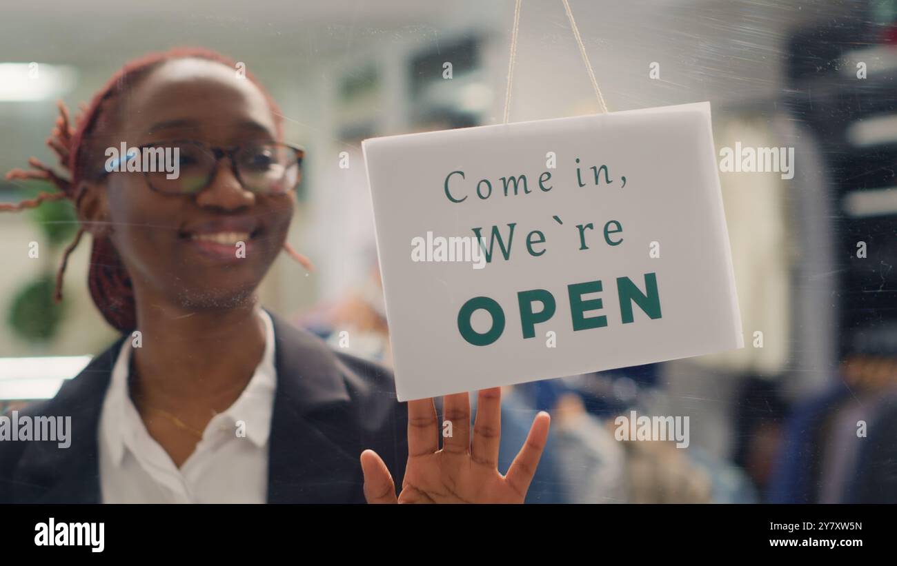 African american worker opening stylish fashion boutique, starting her ...
