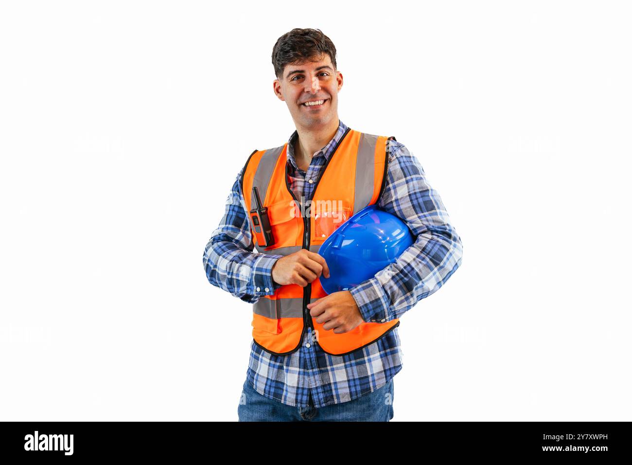 engineer smiles confidently at the camera while holding his blue helmet under one arm. Dressed ...