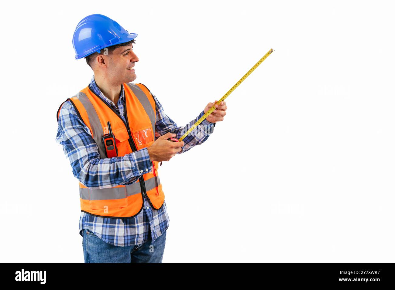 copyspace happy construction worker is confidently holding a measuring ...