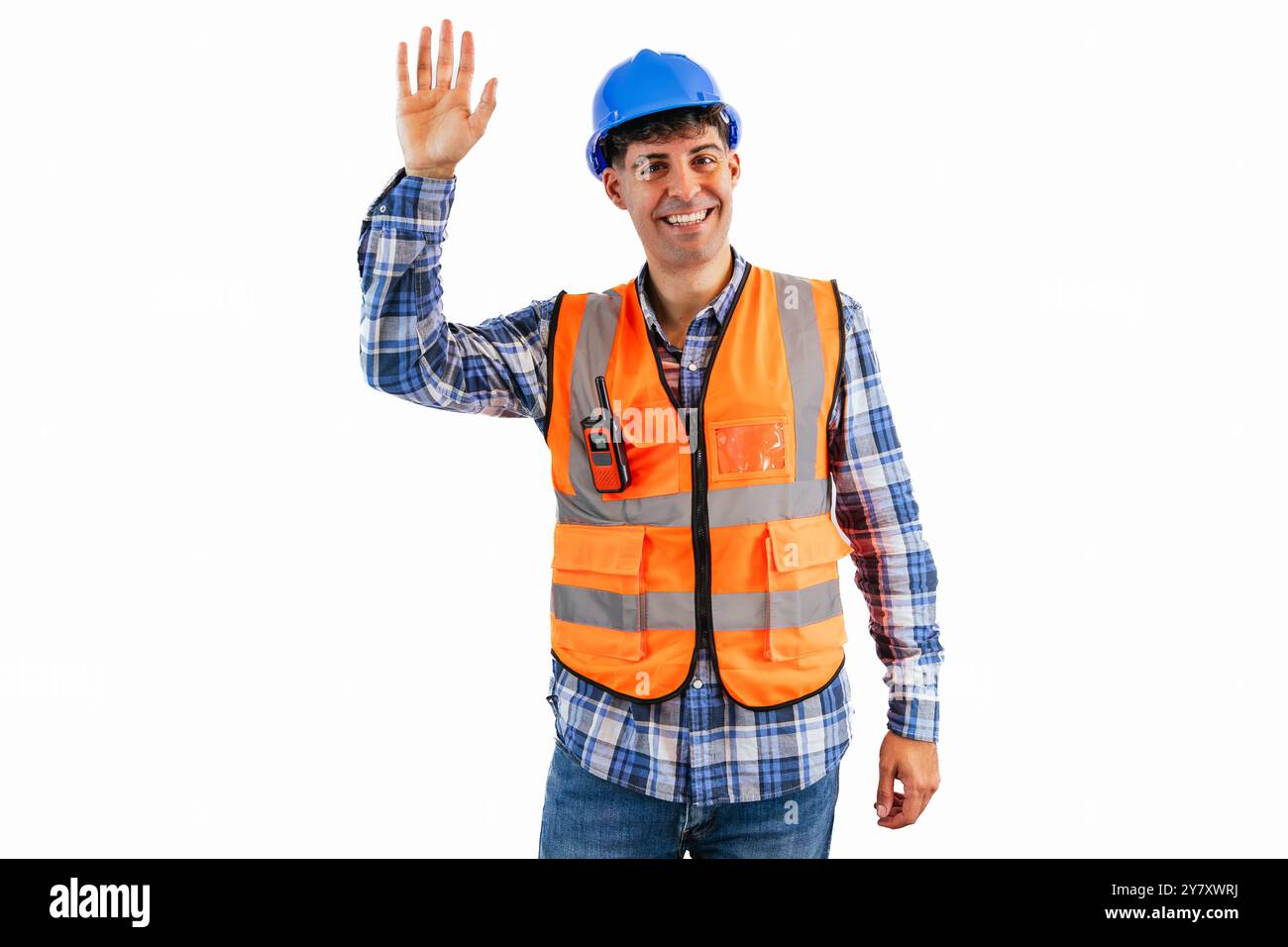 cheerful construction worker smiles and waves at the camera while ...