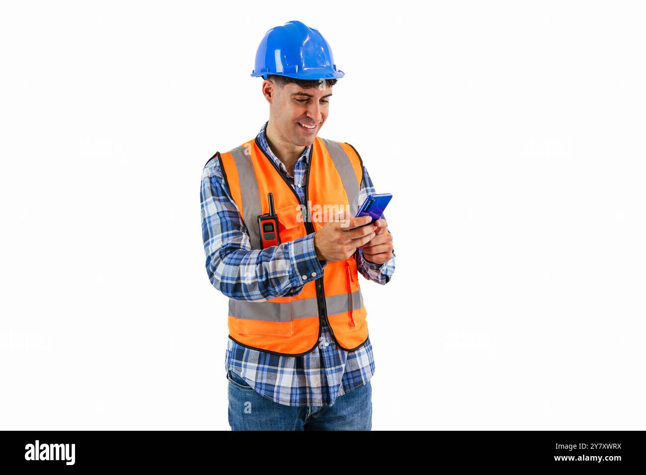 engineer in an orange safety vest and hard hat is focused on sending ...