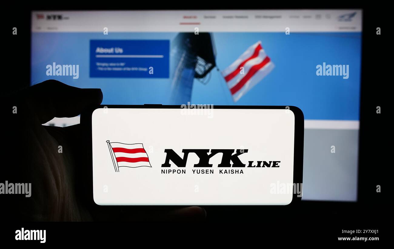 In this photo illustration, a person is holding a cellphone with the ...