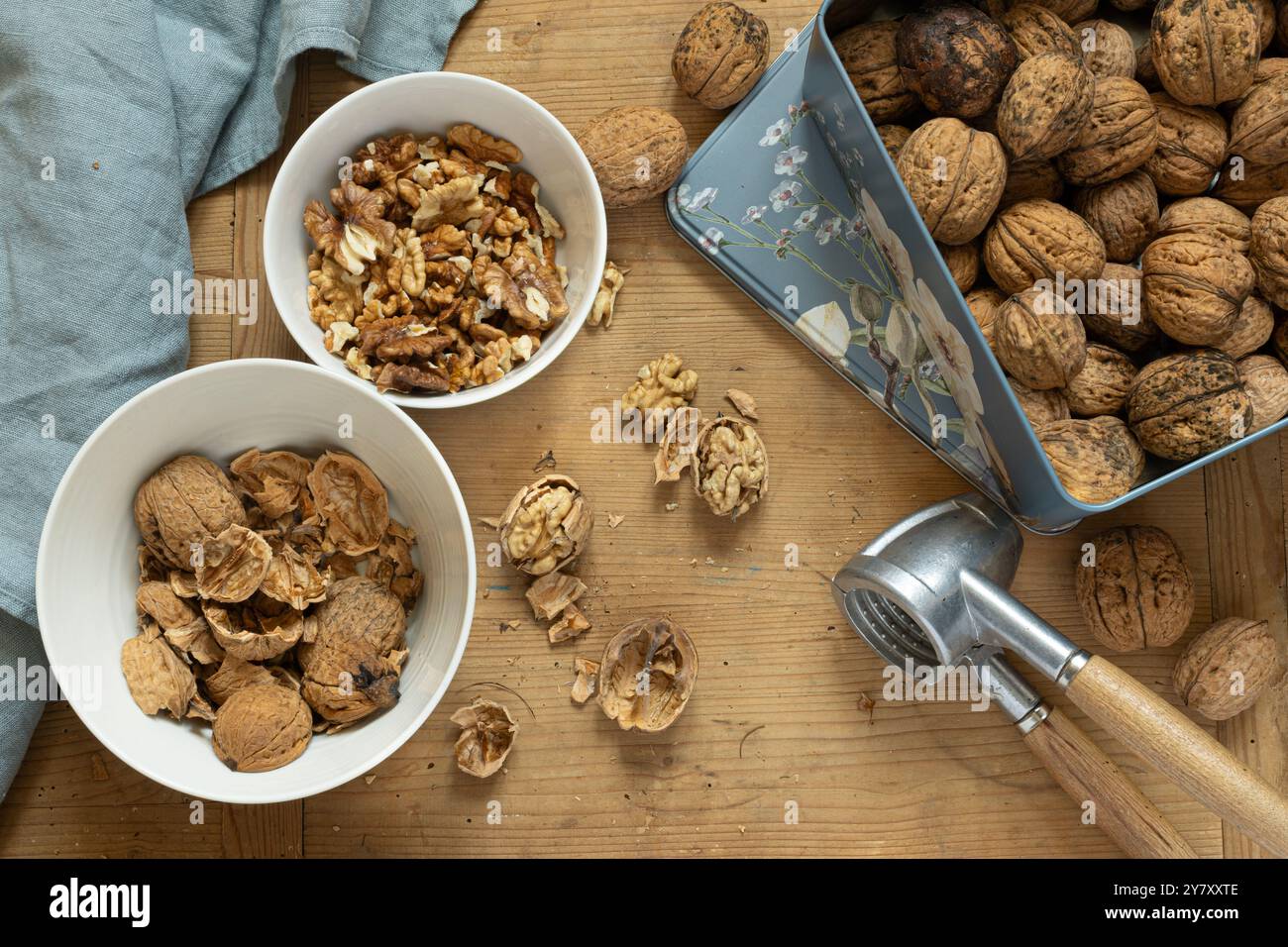 Open and closed walnuts with nutcracker Stock Photo - Alamy