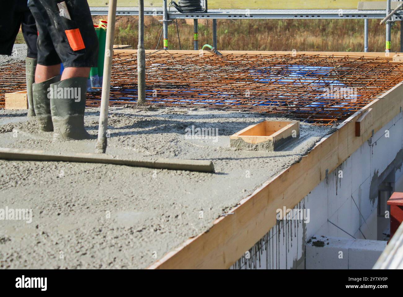 Workers filling the second floor ground with concrete, core and shell ...