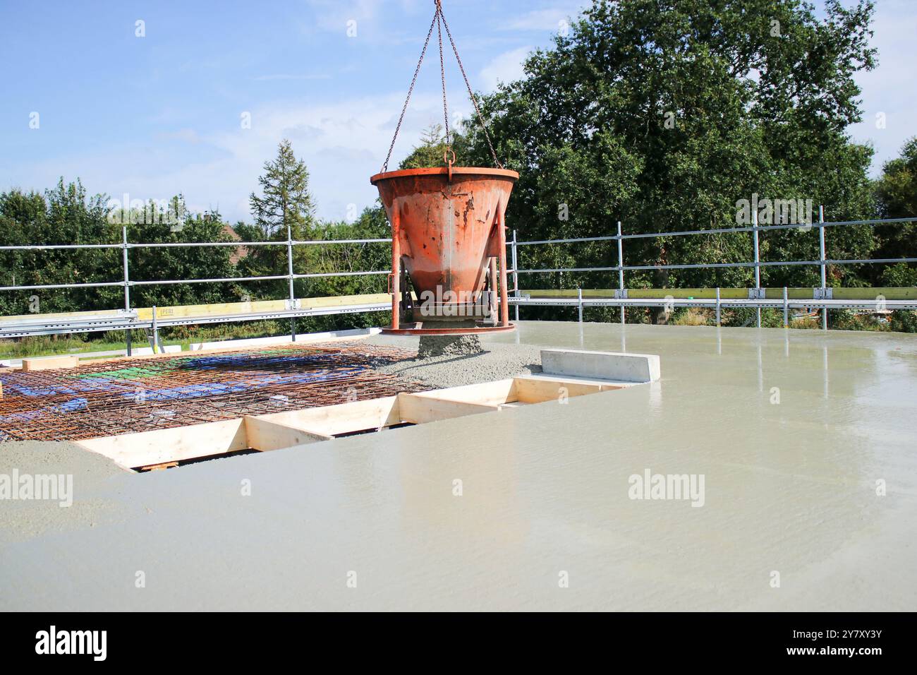 Workers filling the second floor ground with concrete, core and shell ...