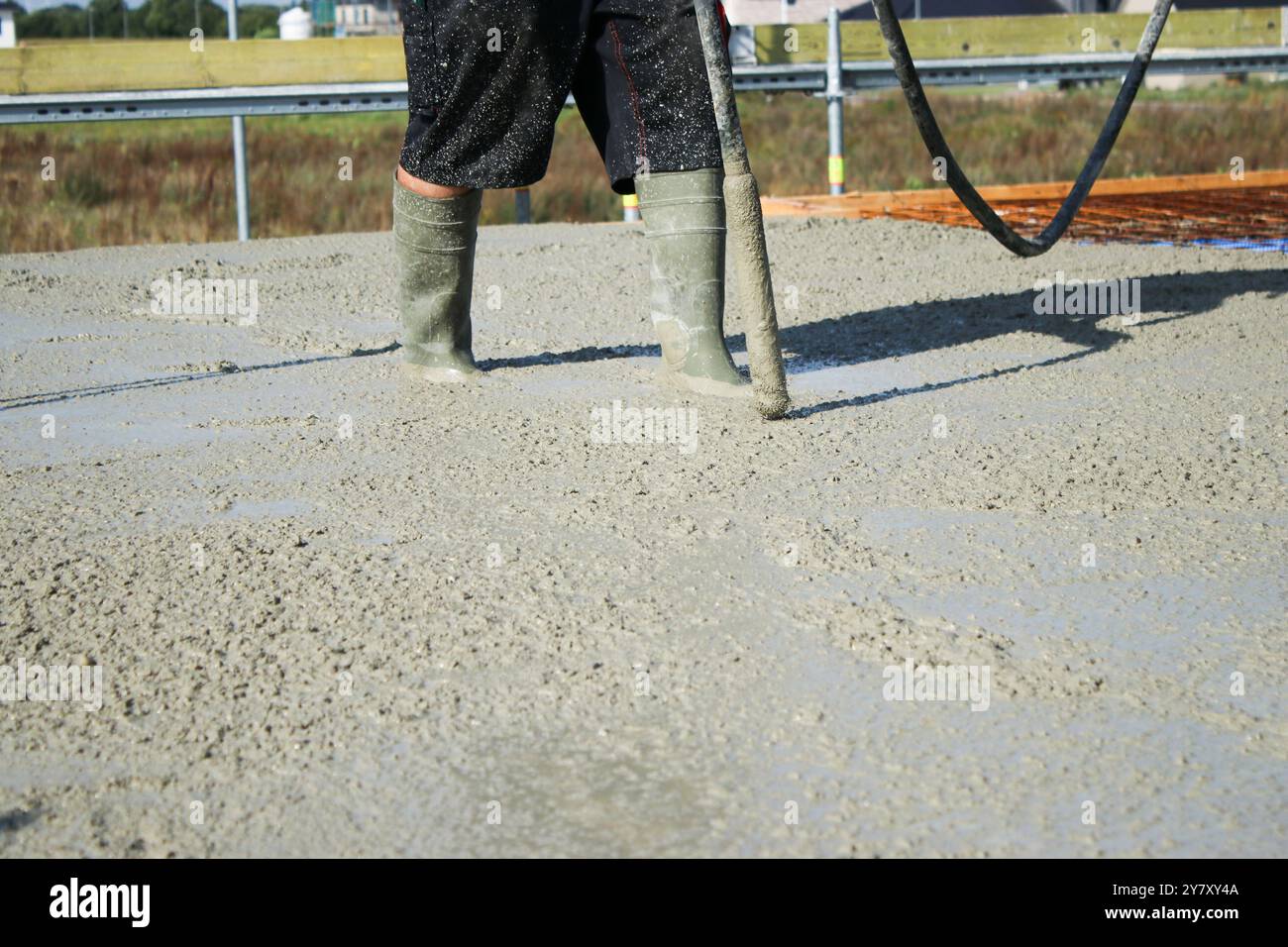 Workers filling the second floor ground with concrete, core and shell ...