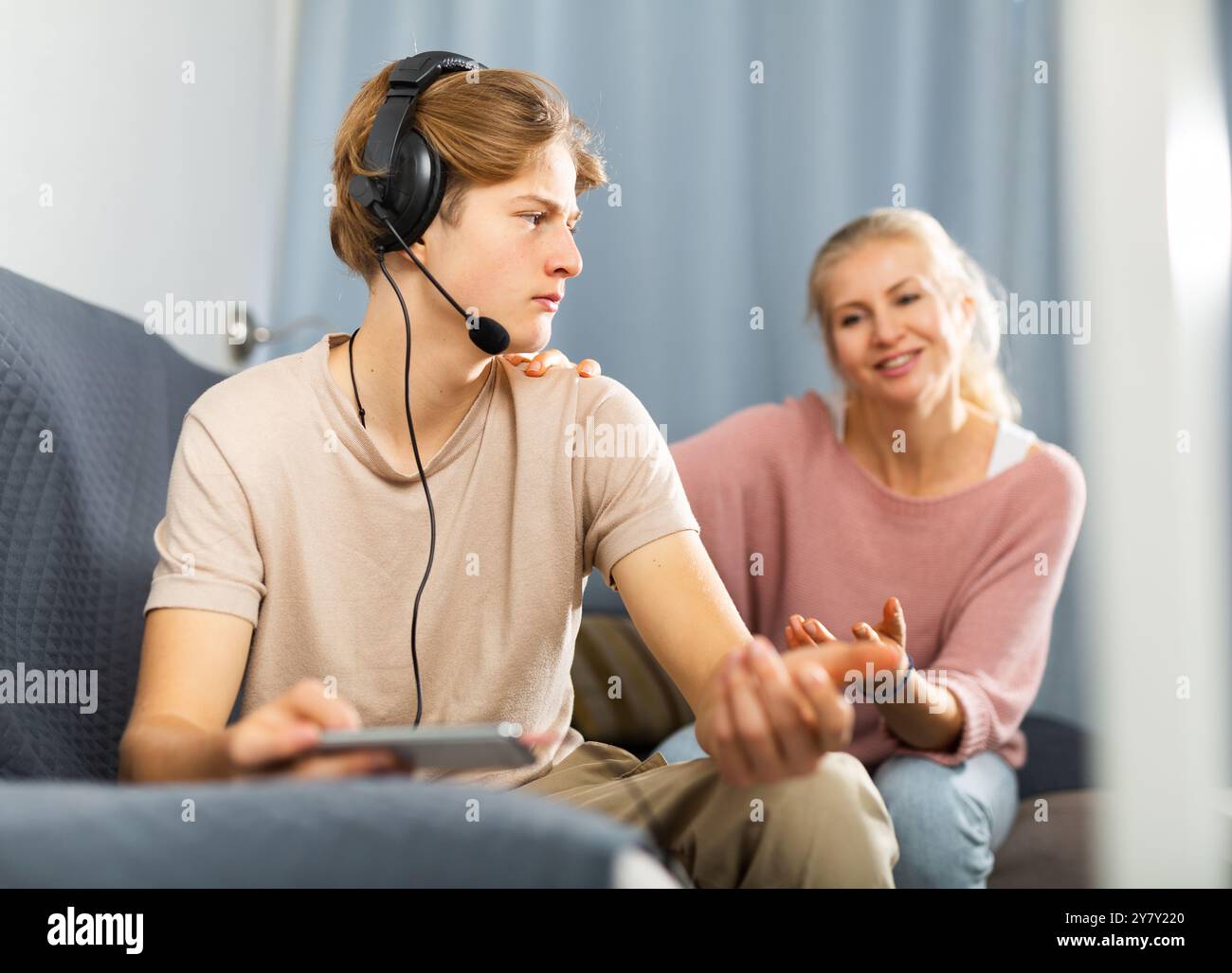 Mother asking for attention of her teenager son Stock Photo - Alamy
