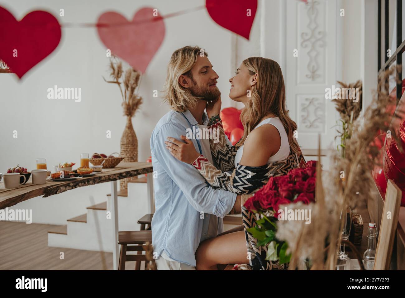 Young romantic couple embracing face to face while celebrating ...