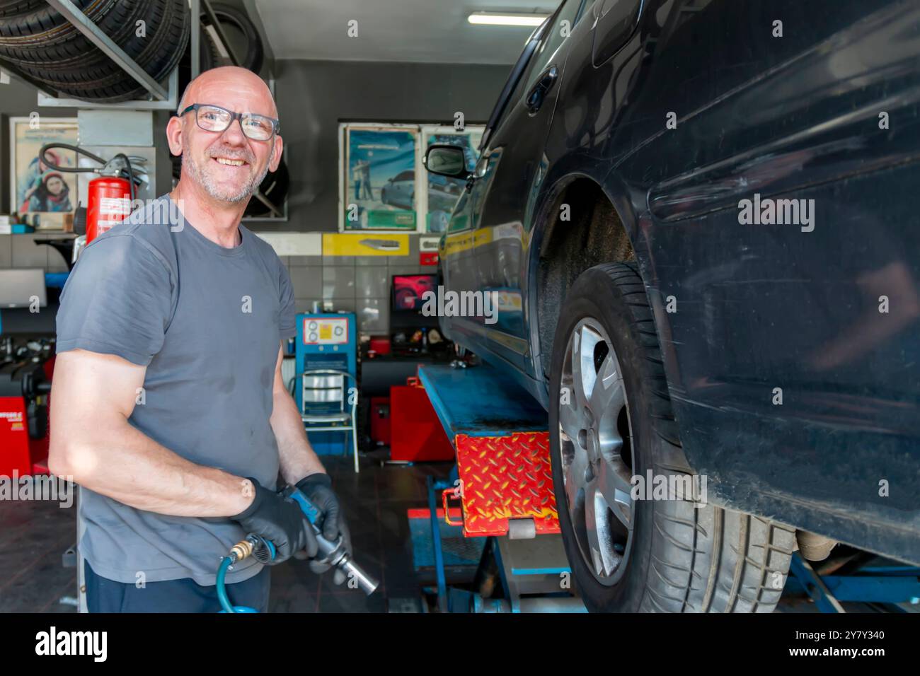 Car wheels maintenance. Car tire wheel replace and mechanic staff ...