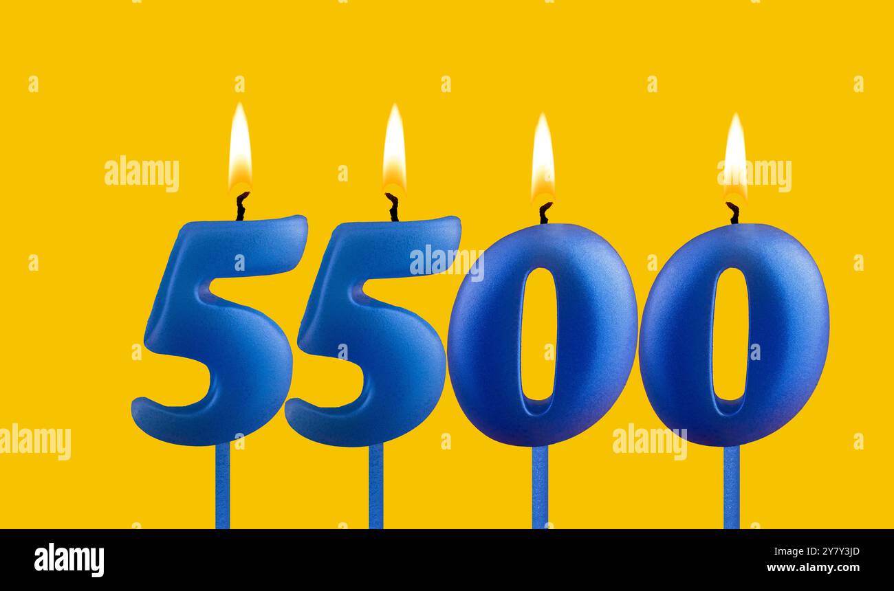 Blue birthday candle on yellow background - Number 5500 Stock Photo - Alamy