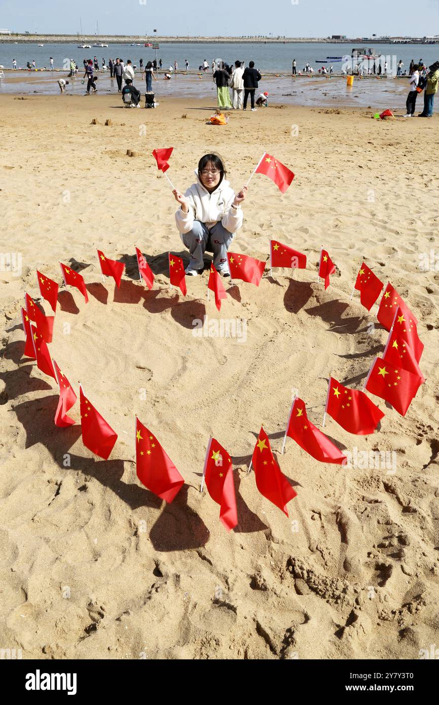 LIANYUNGANG, CHINA - OCTOBER 1, 2024 - A tourist poses for photos next ...