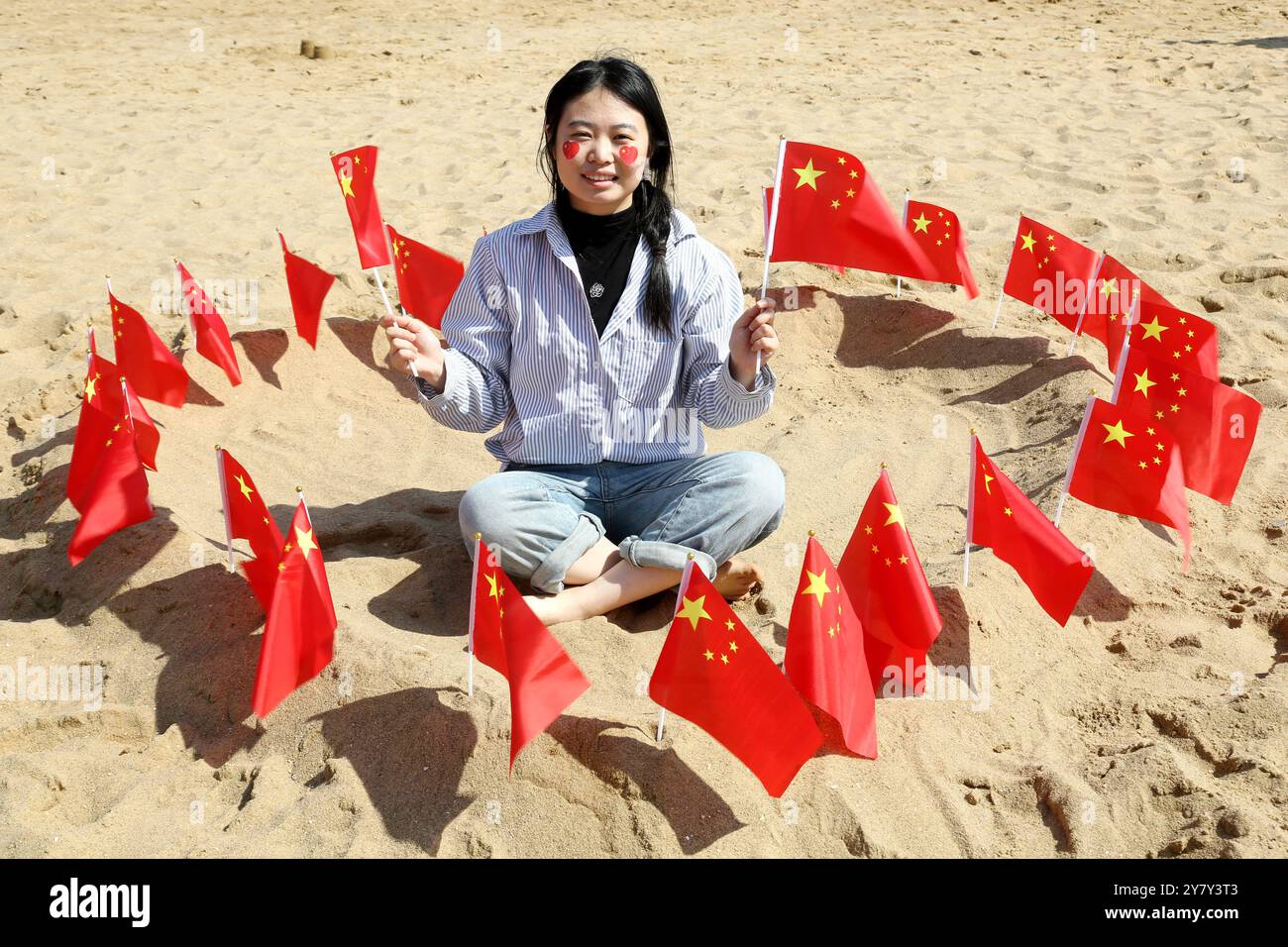 LIANYUNGANG, CHINA - OCTOBER 1, 2024 - A tourist poses for photos next ...