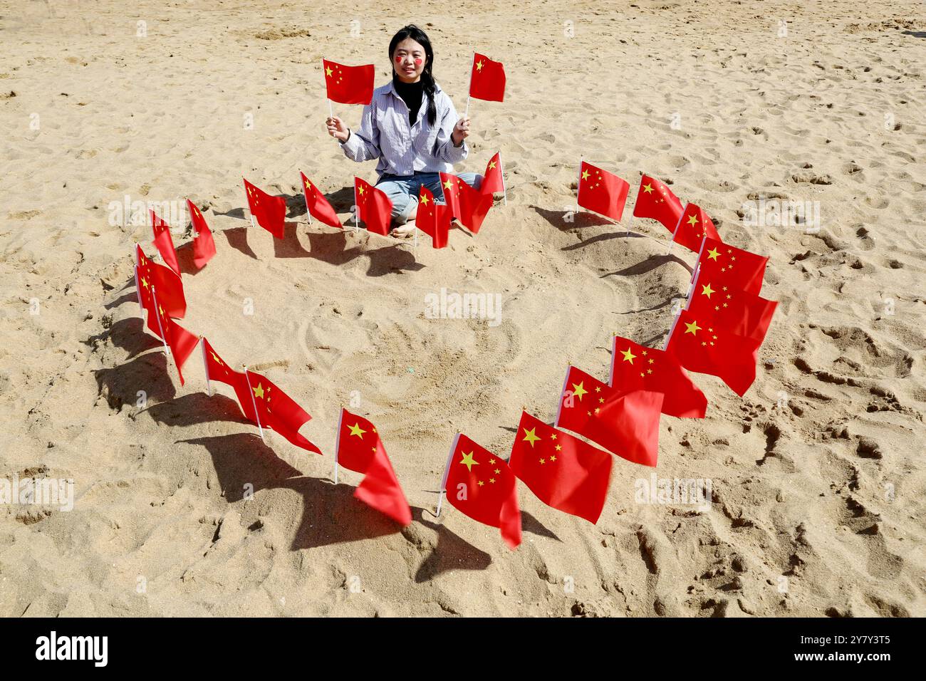 LIANYUNGANG, CHINA - OCTOBER 1, 2024 - A tourist poses for photos next ...