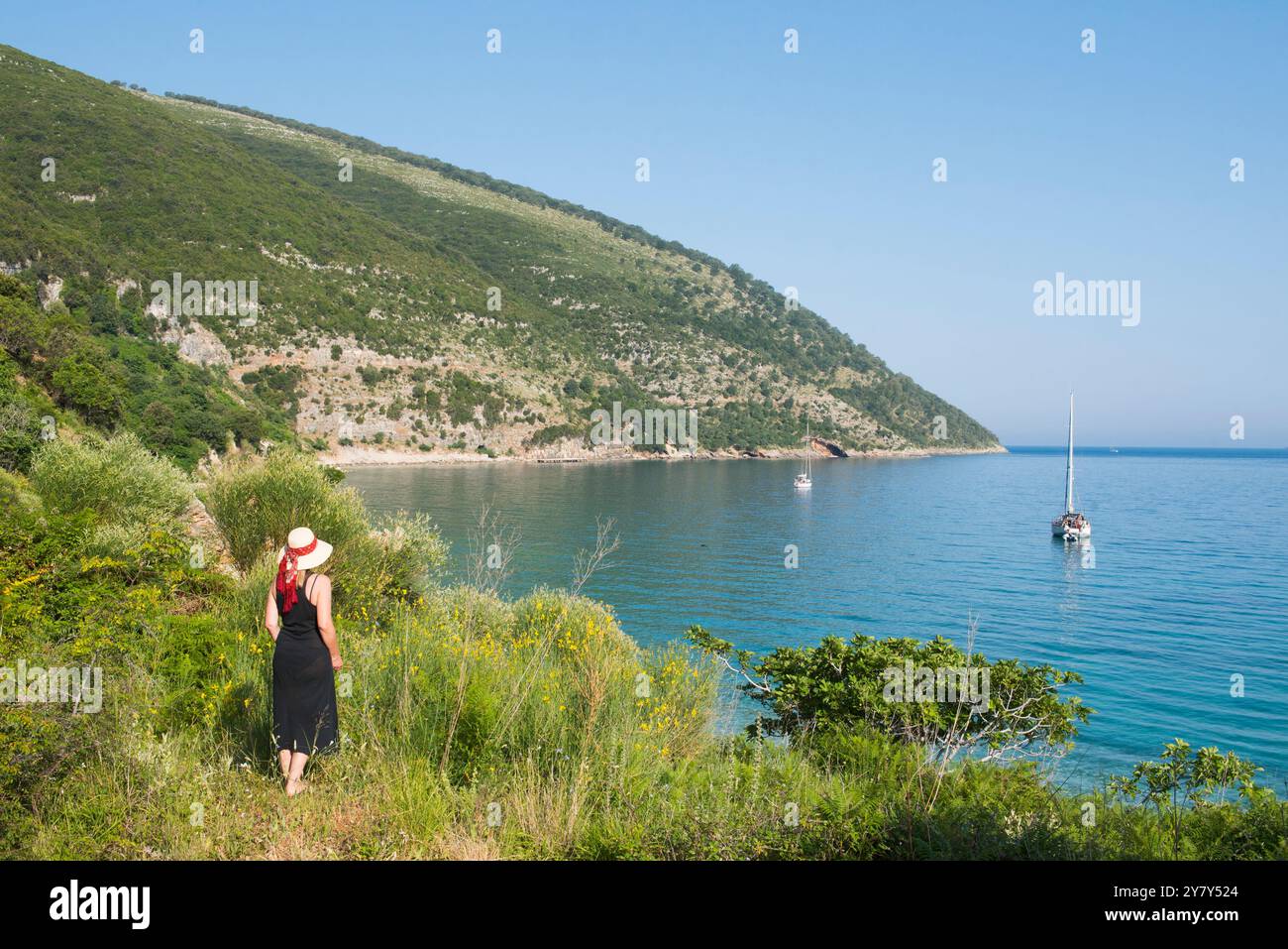 Woman watching a bay of the Peninsula of Karaburun, within the ...