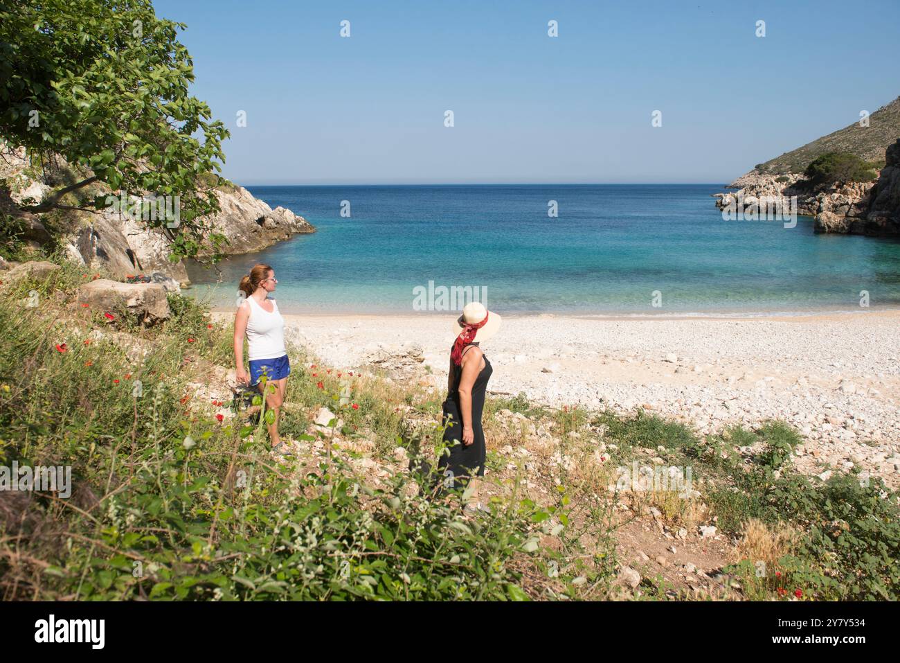 Two women walking along the cove and beach of Brisana, Peninsula of ...