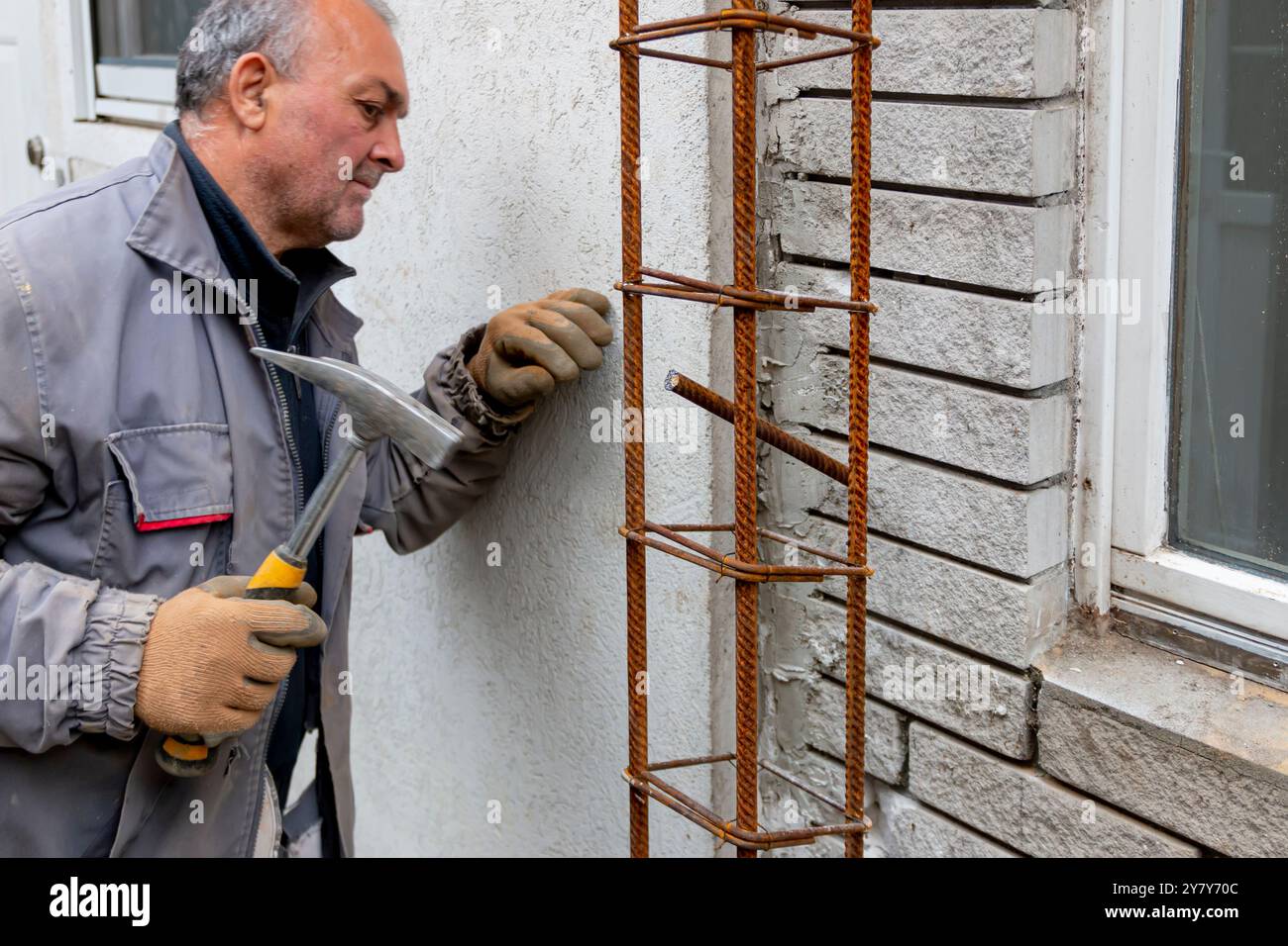Worker is installing and assembling column formworks for concrete ...