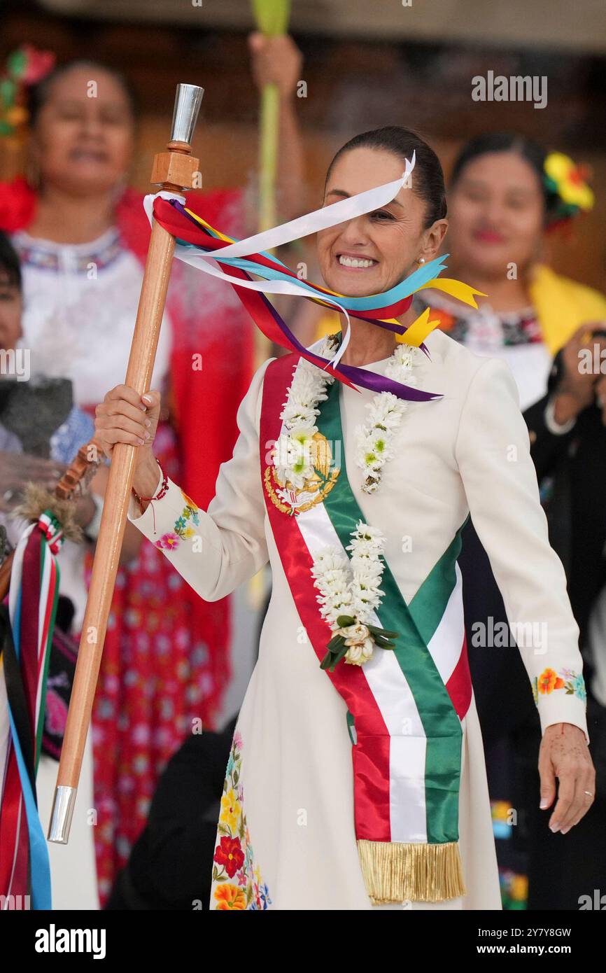 President Claudia Sheinbaum holds a scepter given to her by Indigenous ...