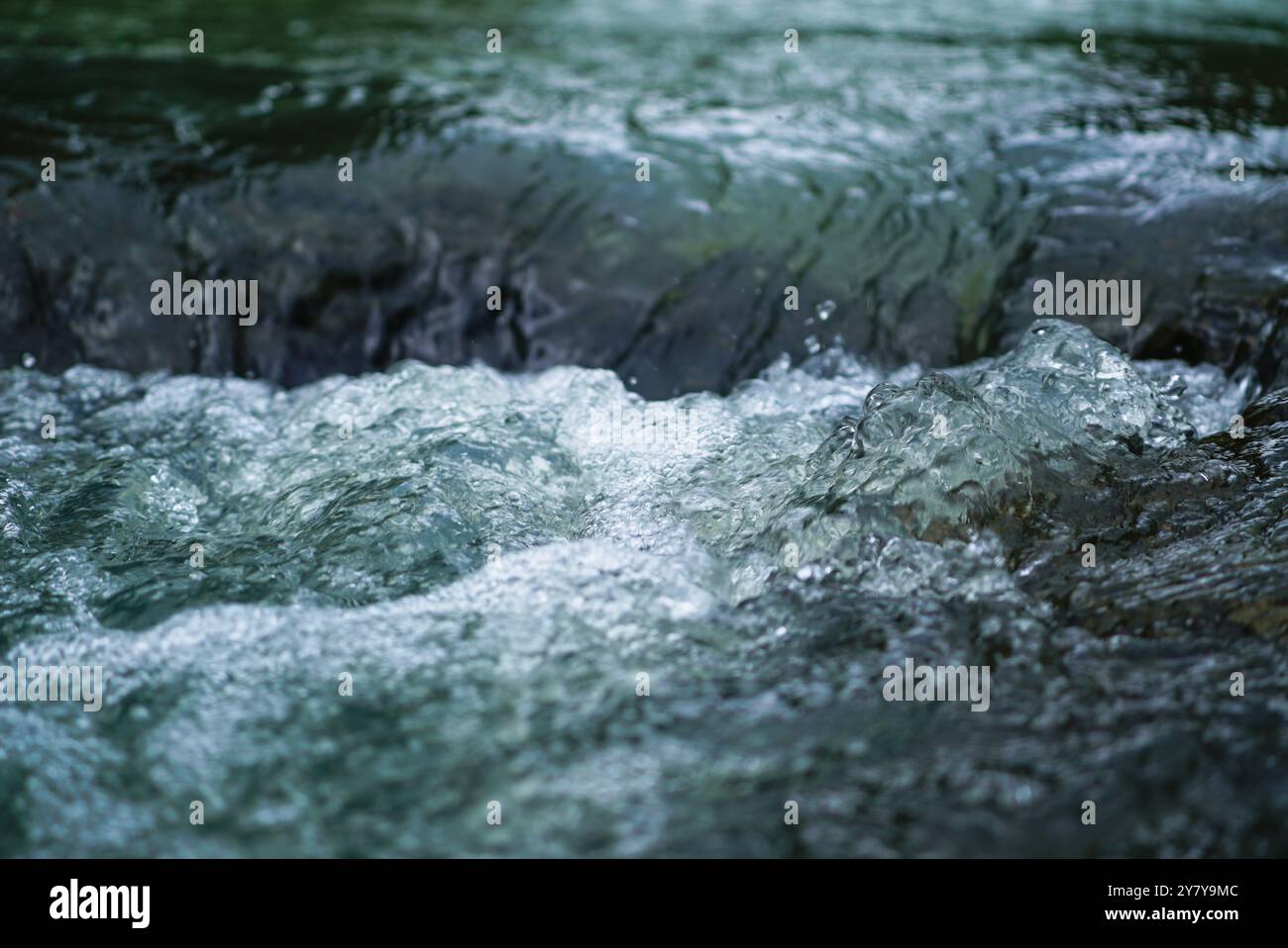 Abstract blurred blue water surface background with ripple and air ...