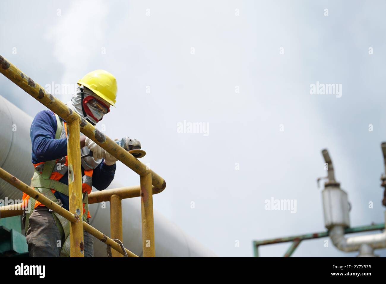 Male welder worker wearing protective clothing fixing welding and ...