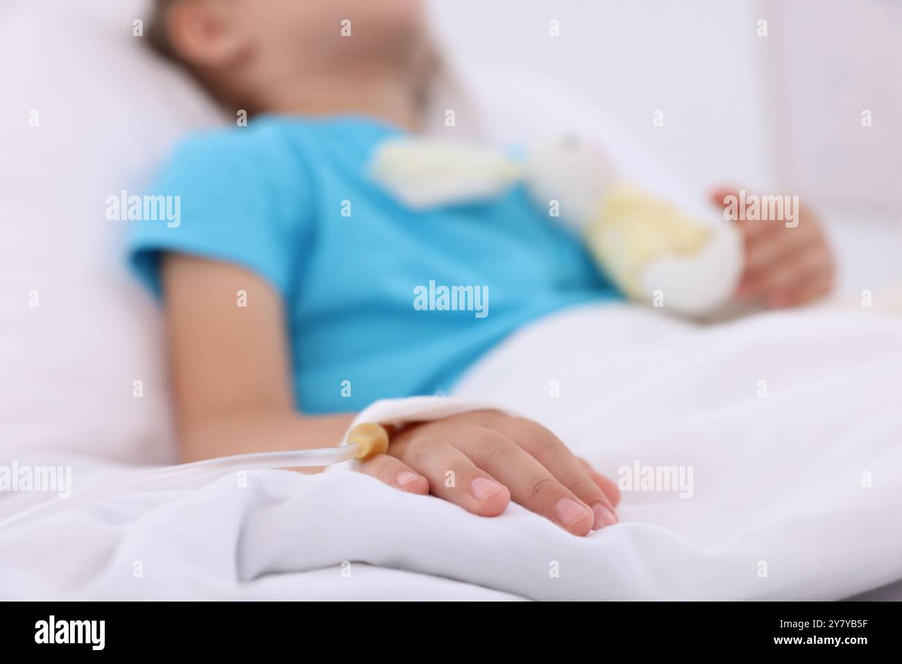 Little girl with IV drip on bed in hospital, closeup Stock Photo - Alamy