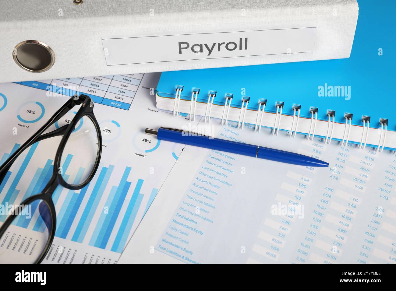 Payroll. Glasses, pen, notebook and graphical charts on table Stock ...