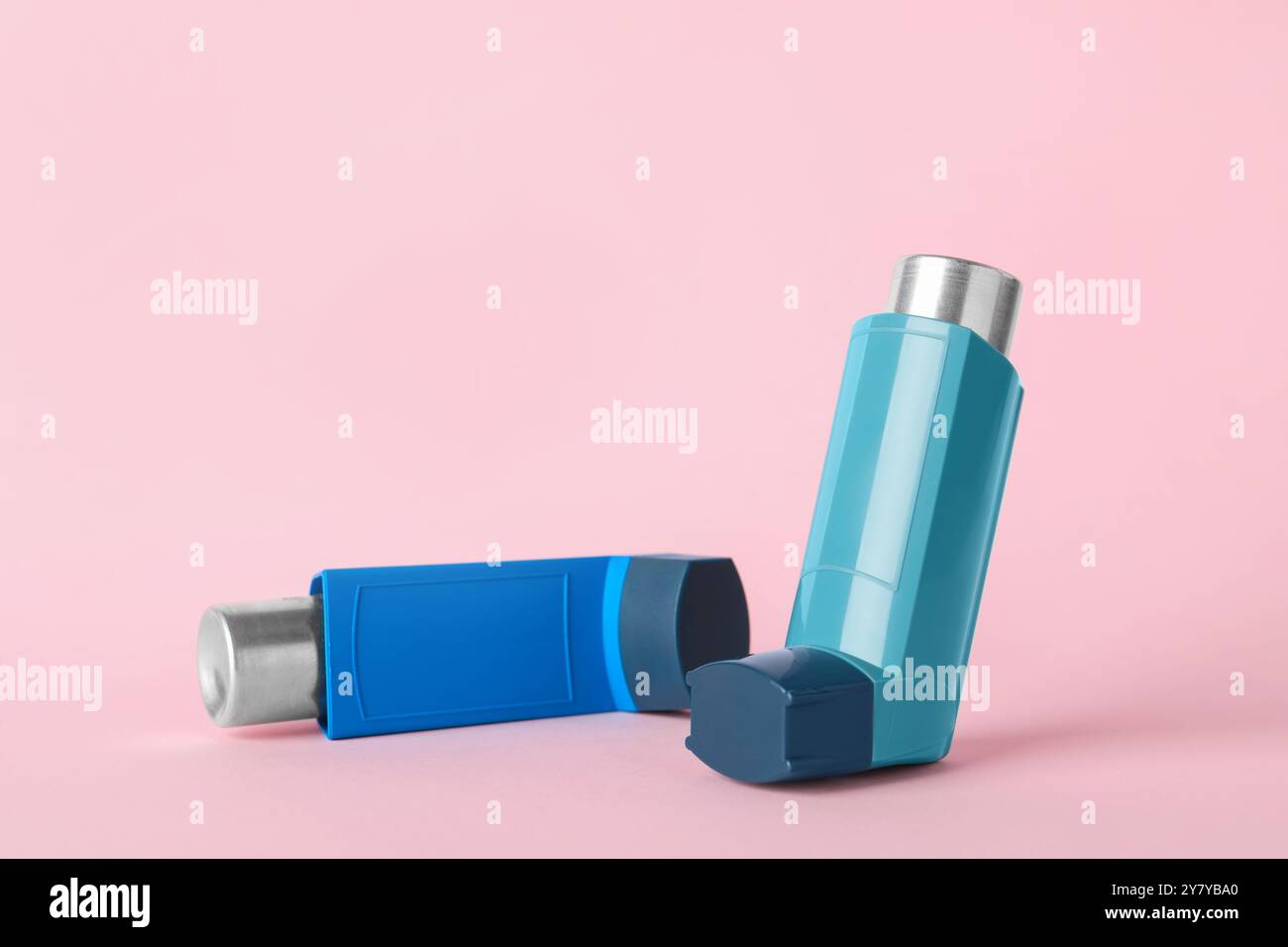 Inhalers on pink background, closeup. Asthma treatment Stock Photo - Alamy