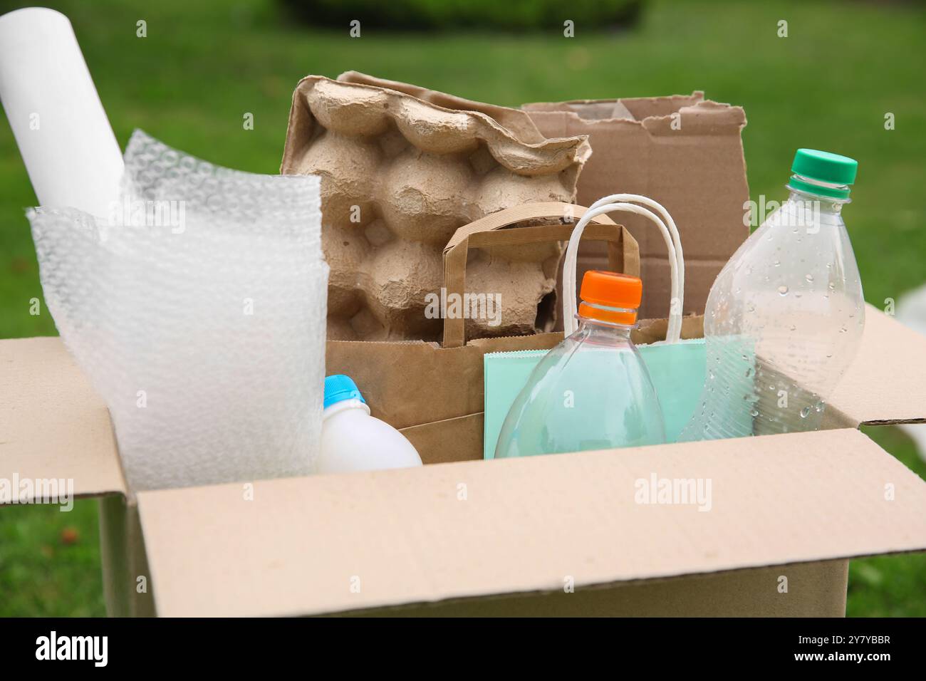 Recycling. Different garbage in cardboard box outdoors Stock Photo - Alamy