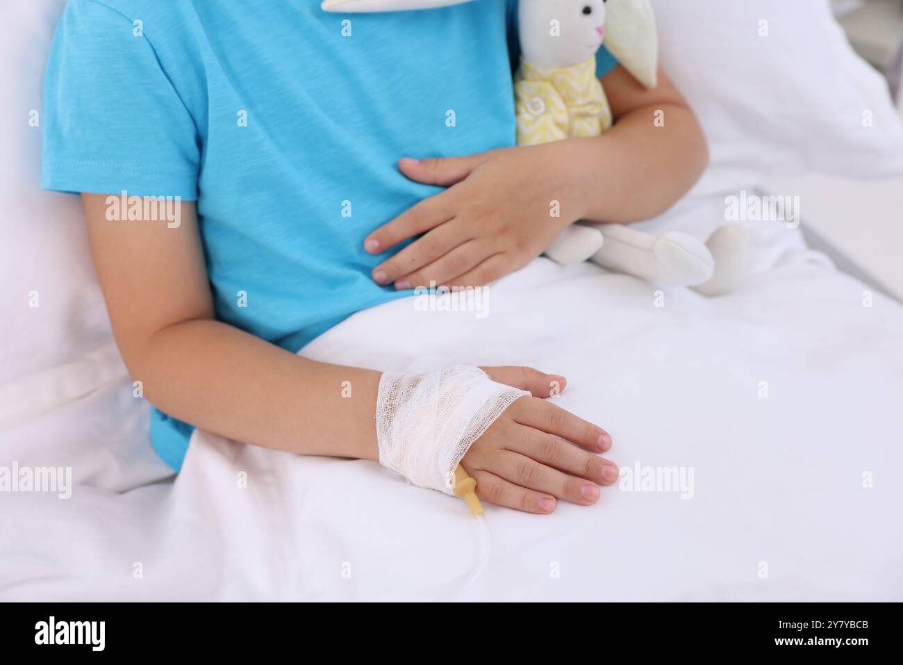 Little girl with IV drip on bed in hospital, closeup Stock Photo - Alamy